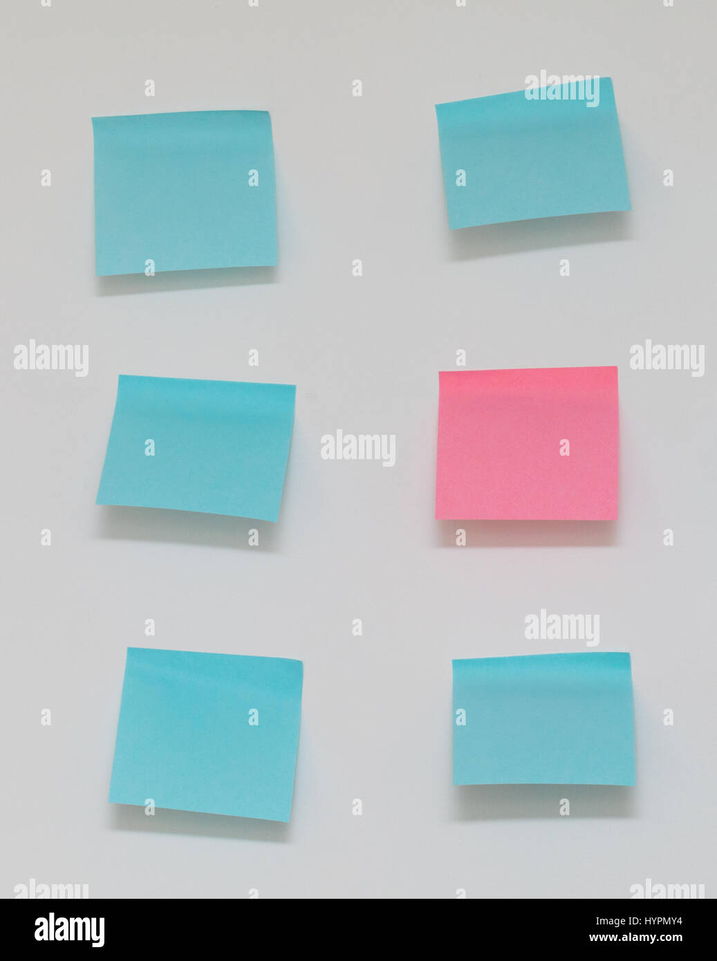 Single pink post it note in sea of blue post it notes Stock Photo - Alamy