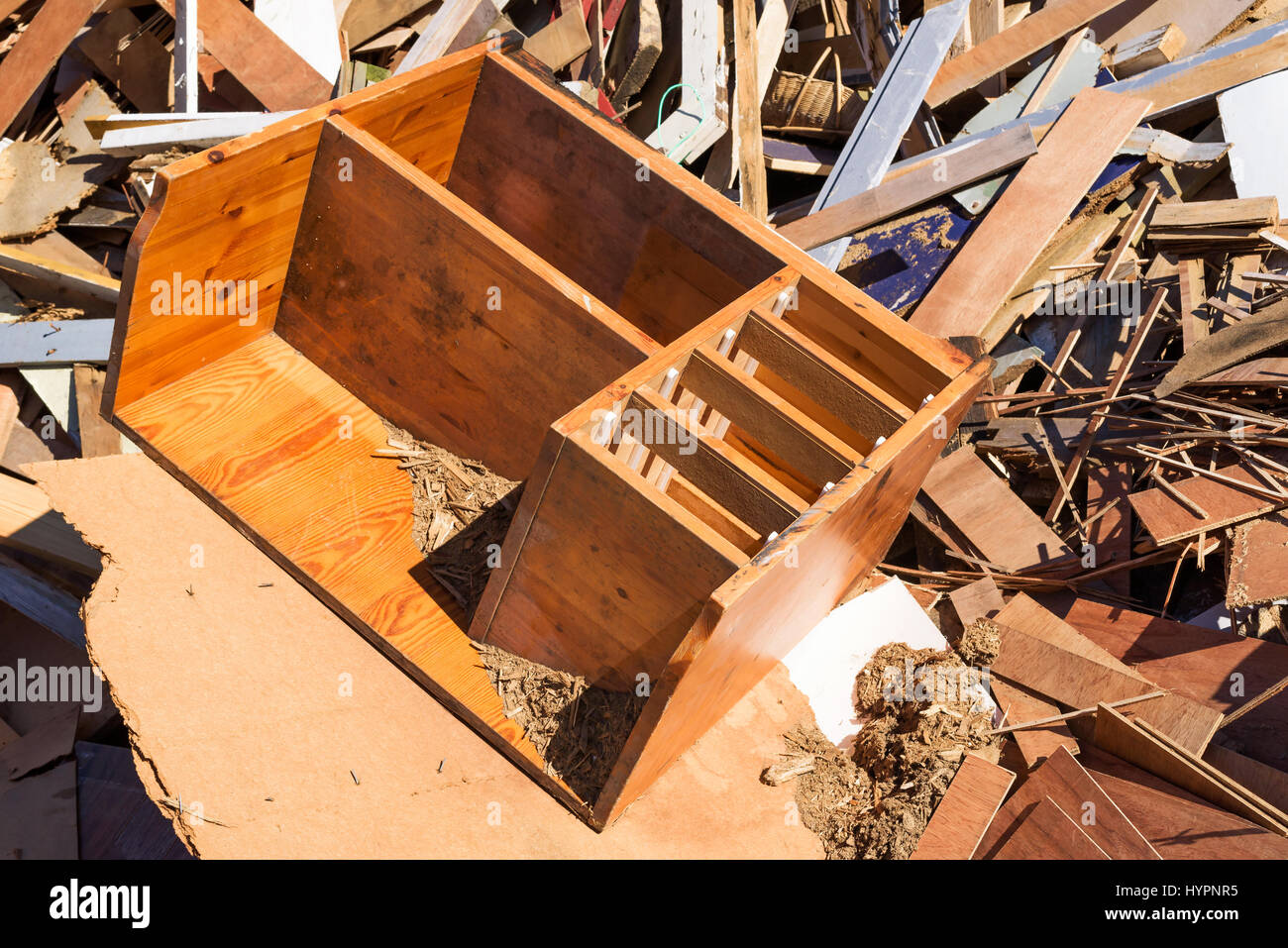 Trashed cabinet in a pile of sorted wooden debris Stock Photo - Alamy
