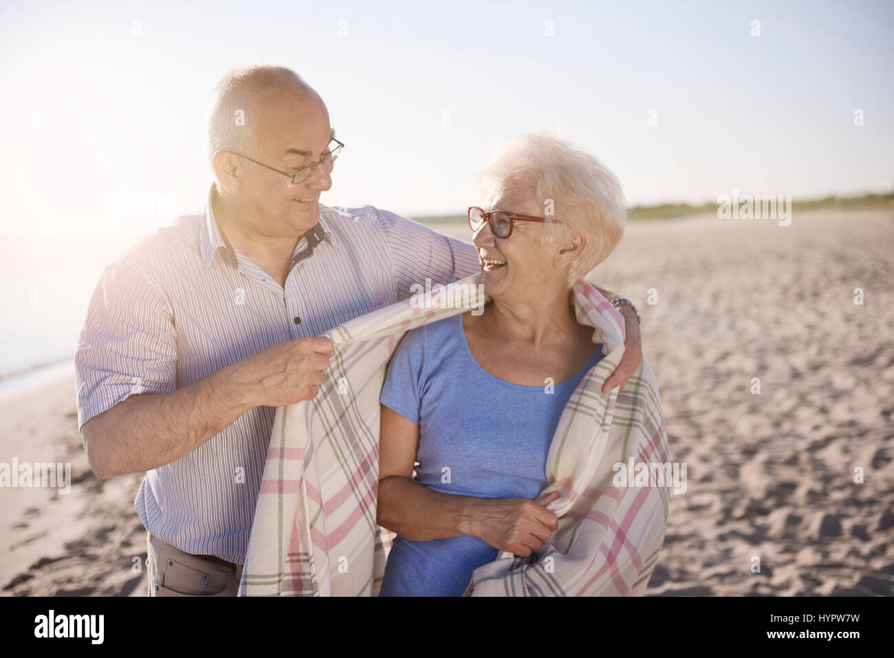 Helpful husband warming up his wife Stock Photo - Alamy