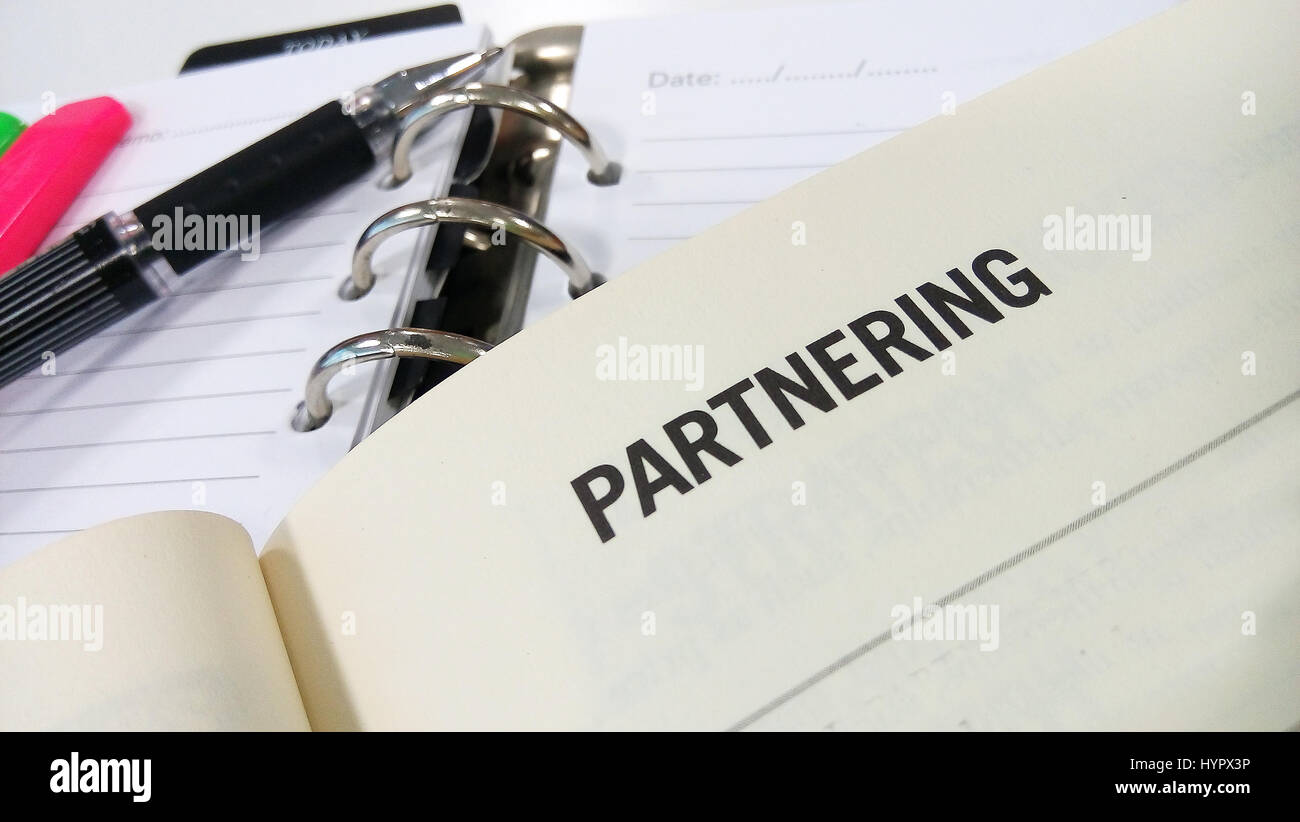 Partnering word printed on a white book Stock Photo - Alamy