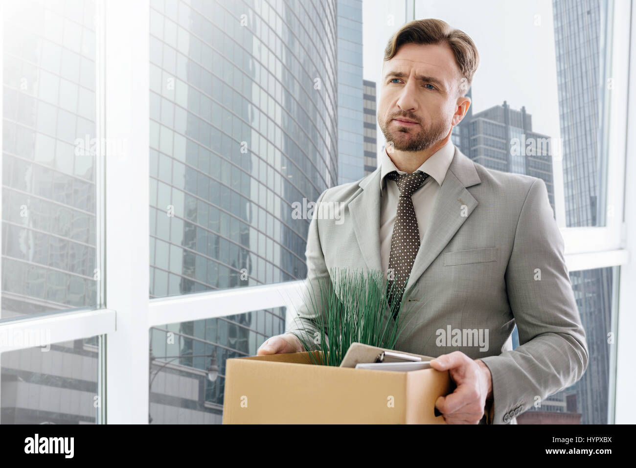 Jobless man standing in the office Stock Photo - Alamy