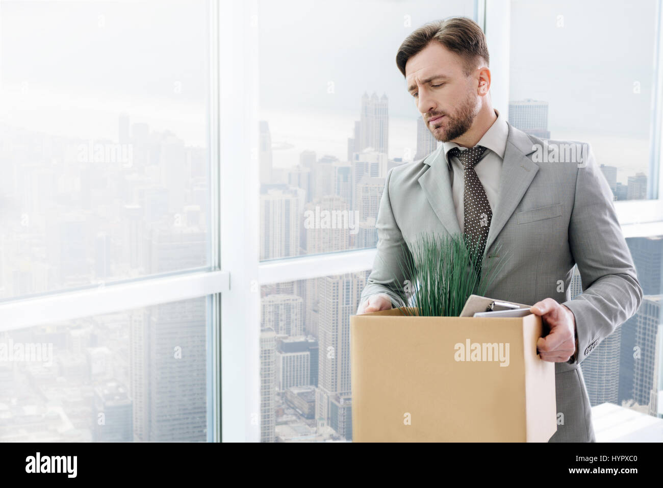 Gloomy sad man being fired Stock Photo - Alamy