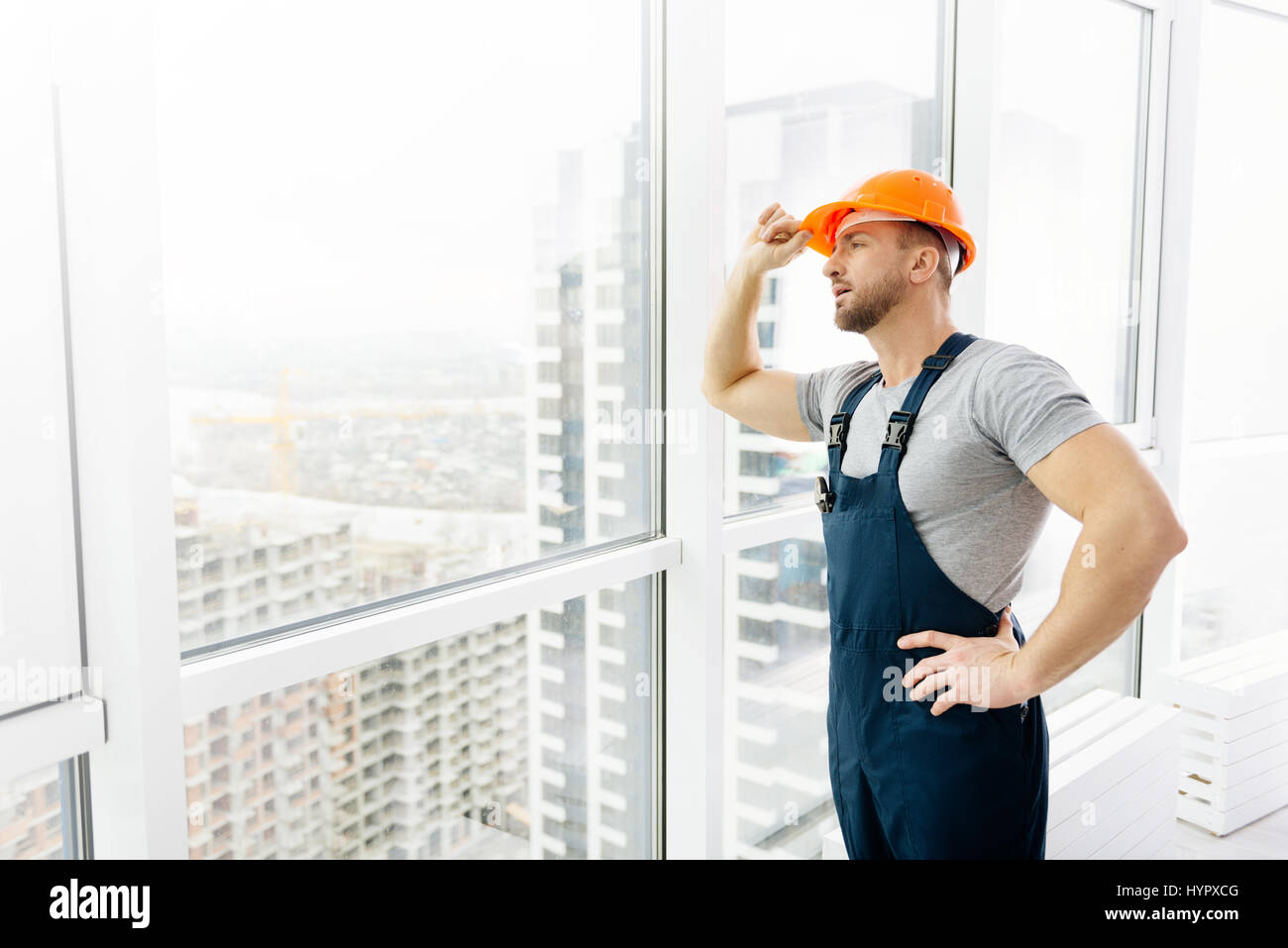 Professional construction engineer standing near window Stock Photo - Alamy