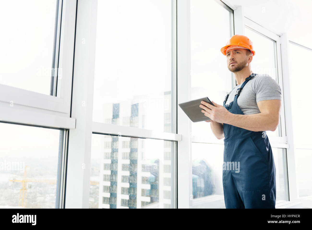 Low angle of professional construction engineer using tablet Stock ...