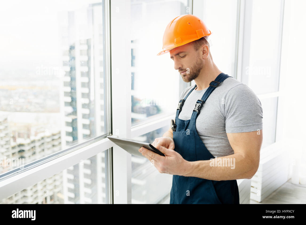 Important work. Pleasant professional construction engineer standing in ...