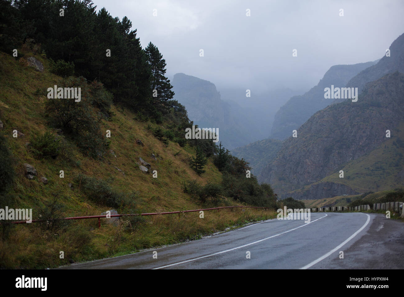 Cinematic road landscape. Asphalt Road throuth the mountains. With ...