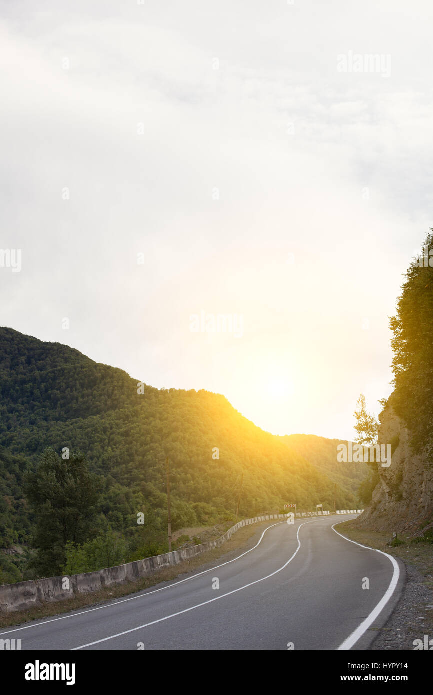 Cinematic road landscape. Asphalt Road throuth the mountains. With ...