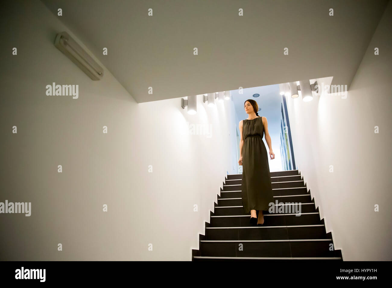 Person coming down stairs hi-res stock photography and images - Alamy