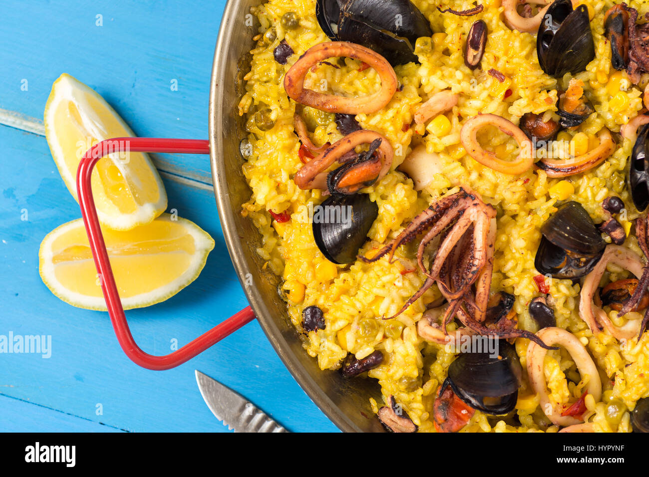 Spanish Seafood Paella in Traditional Pan on Rustic Wooden Table Stock ...