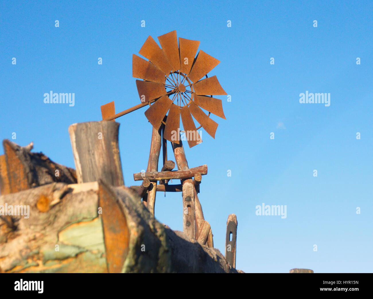 Rusty windmill with blue sky in the background Stock Photo - Alamy