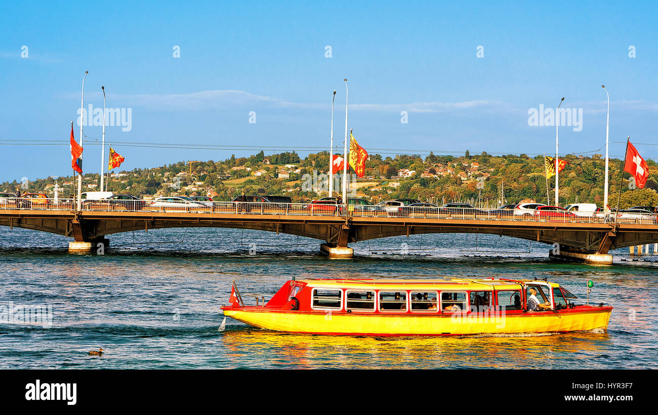 Excursion ferry on Geneva Lake and Pont des Bergues bridge with flags ...