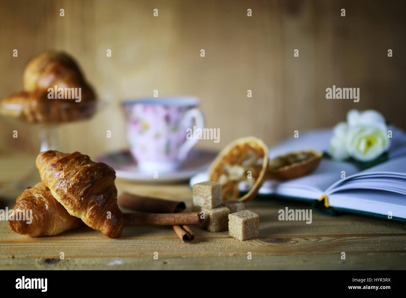 cup with tea croissant book Stock Photo - Alamy