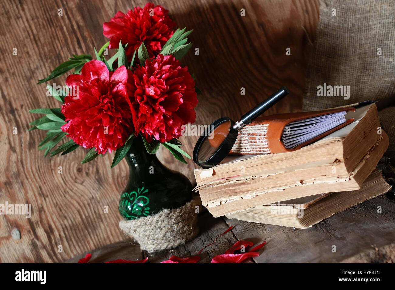 old book flower on wooden table Stock Photo - Alamy