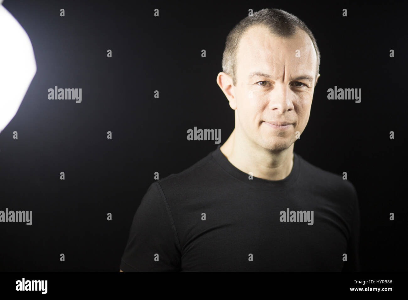 Attractive handsome slim healthy man aged in 40's in black t-shirt ...