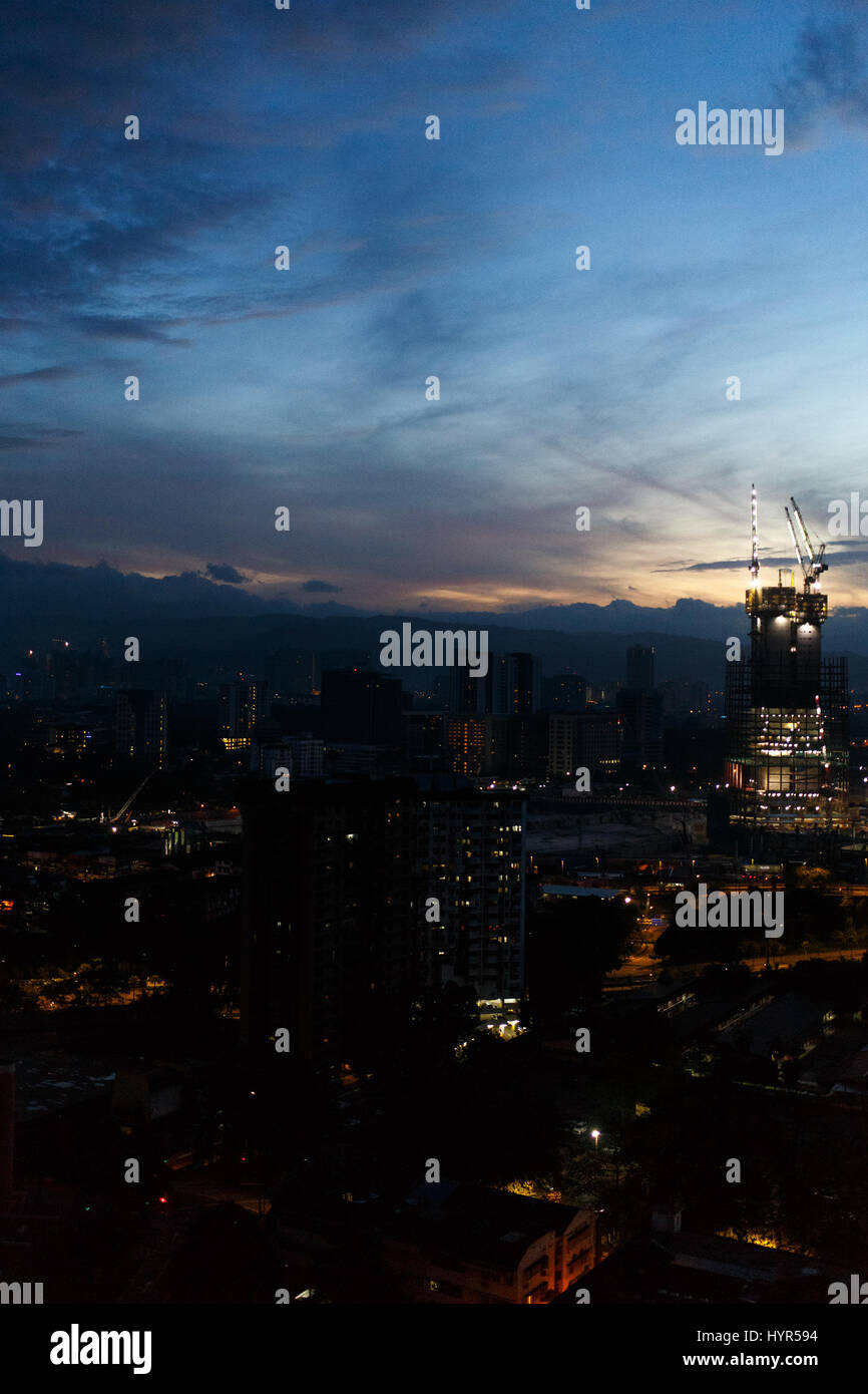 Town with burning lights, sunset Stock Photo - Alamy