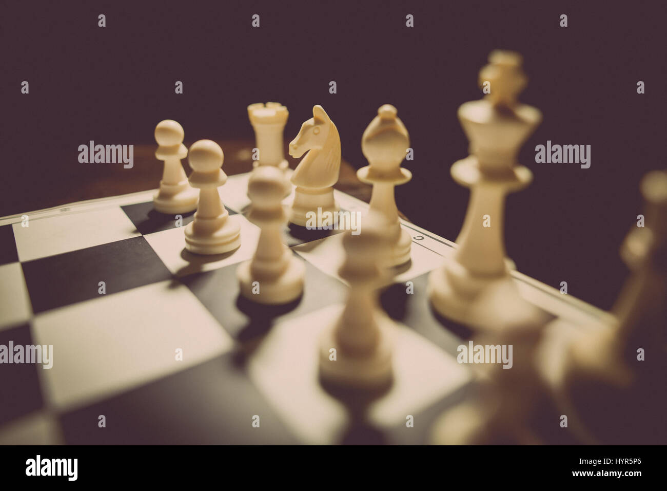 Image of the white pieces on a chess board, with shallow depth of field ...