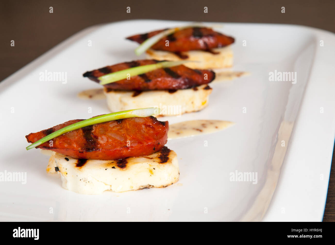 Halloumi cheese and grilled meat starter on white plate Stock Photo - Alamy