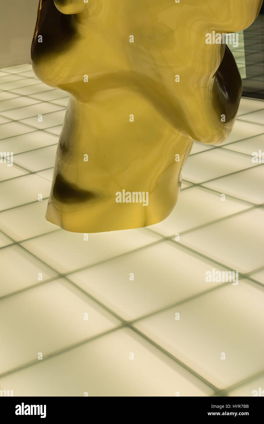 White Floor with Backlight Tile and Golden Sculpture Stock Photo - Alamy