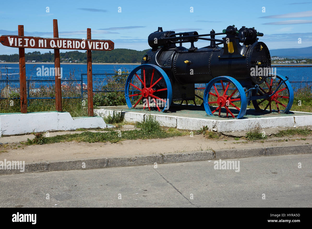 Old steam engine in a coastal garden in Quellon, a fishing town on the ...