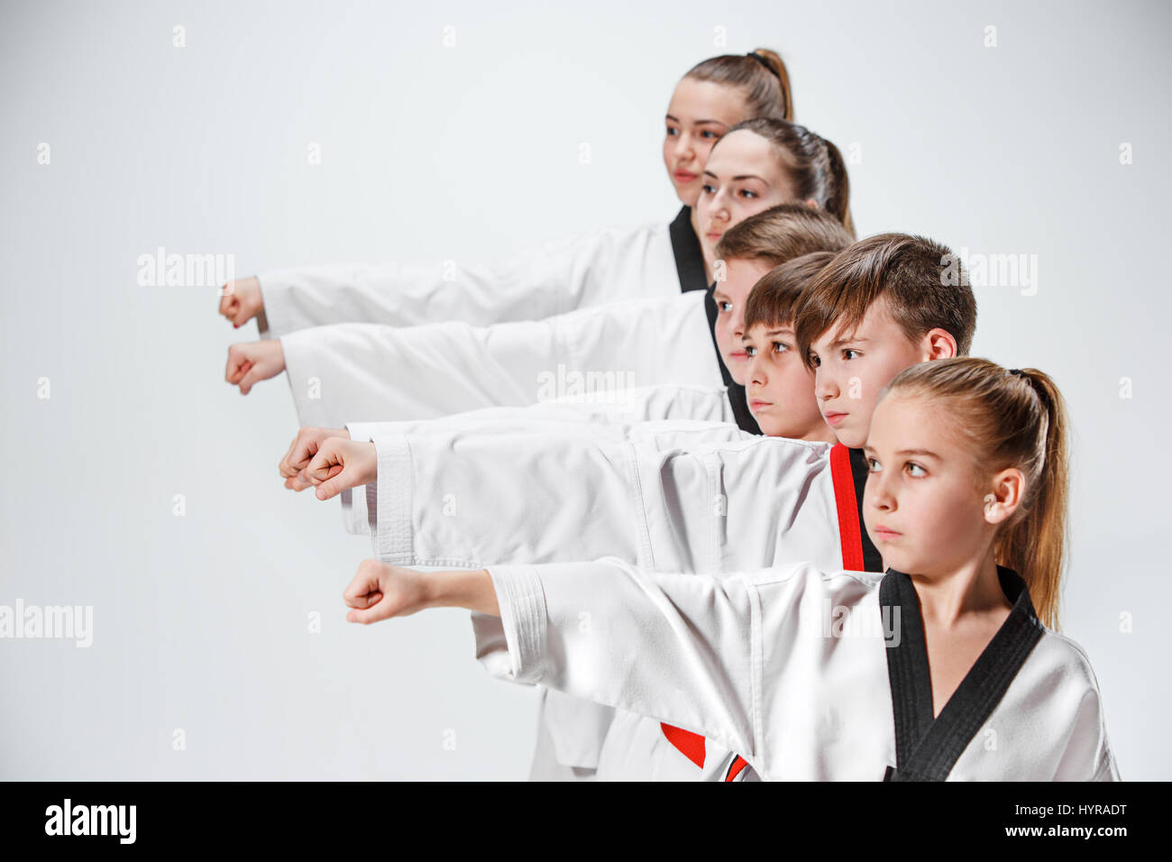 The studio shot of group of kids training karate martial arts and ...