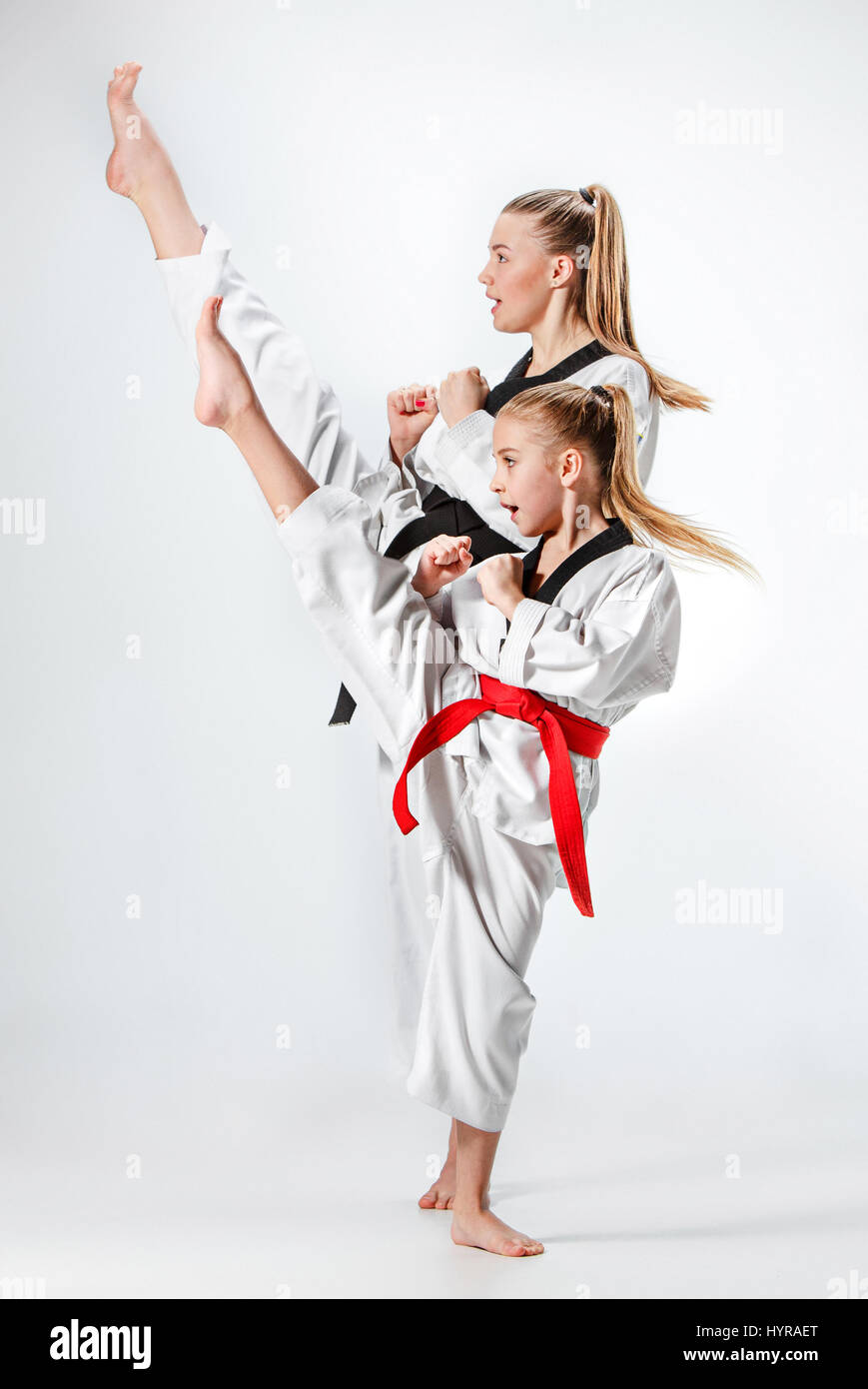 The studio shot of group of kids training karate martial arts on gray ...