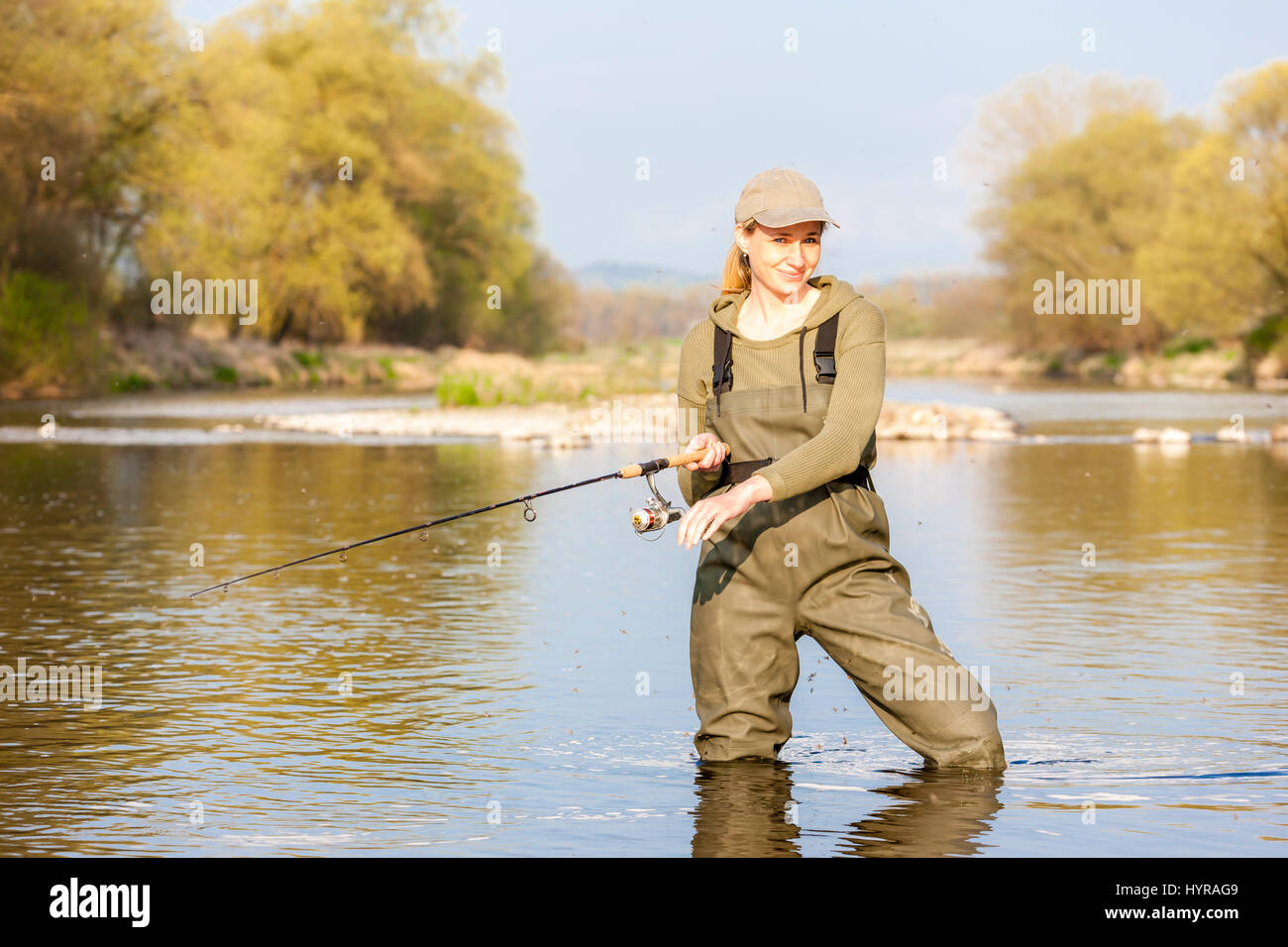 woman fishing in the river in spring Stock Photo - Alamy