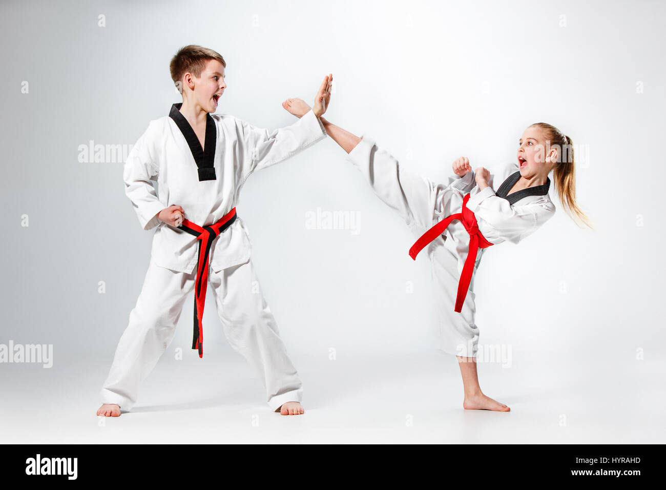 The studio shot of group of kids training karate martial arts on gray ...