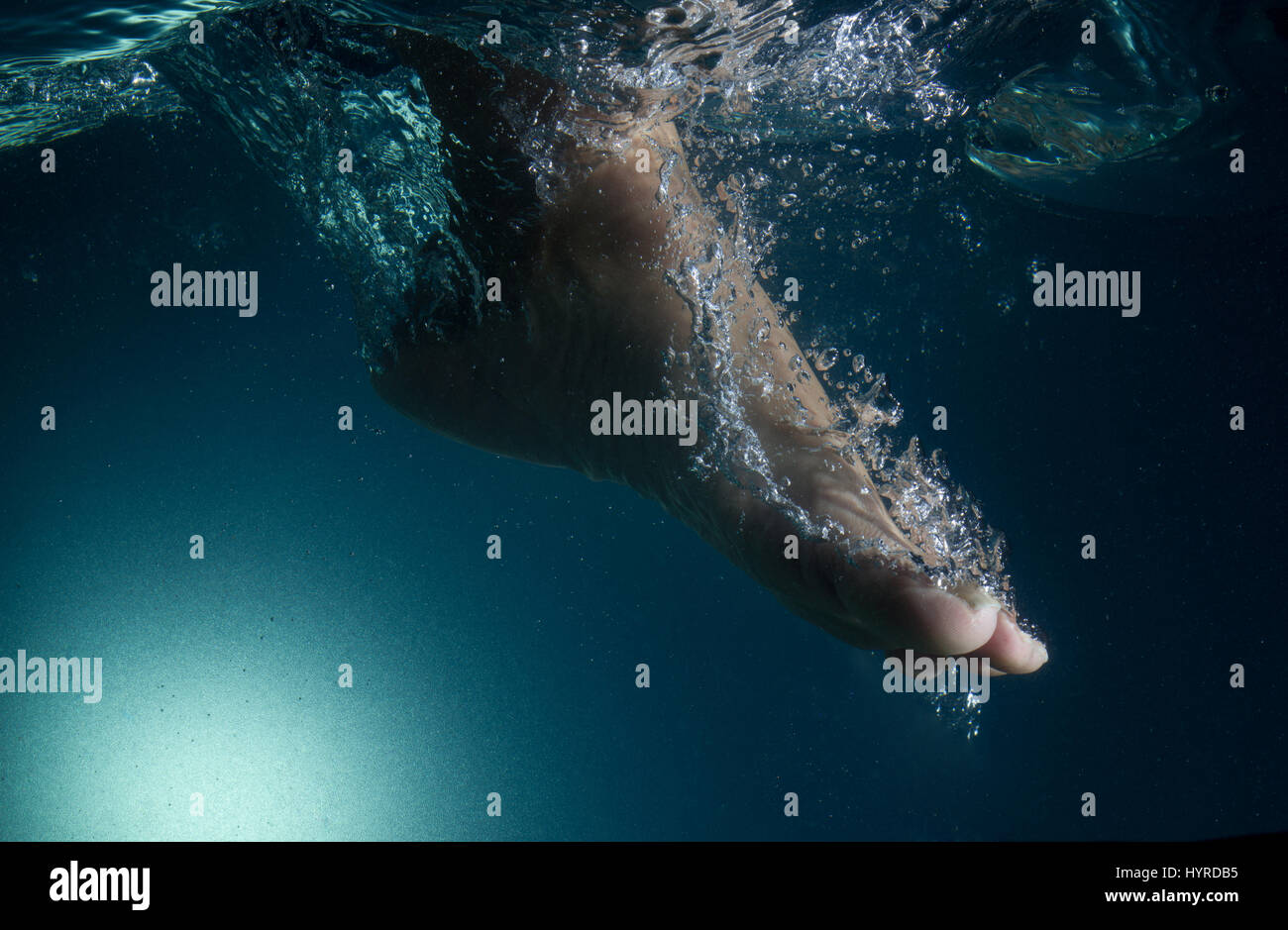 Woman's foot plunging into water Stock Photo - Alamy