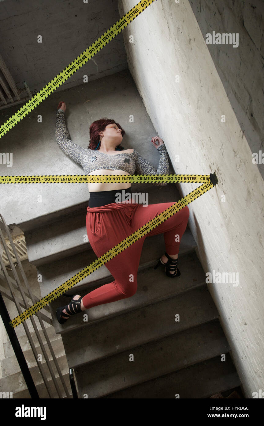 Model posing as a victim of crime at a crime scene indoors Stock Photo ...