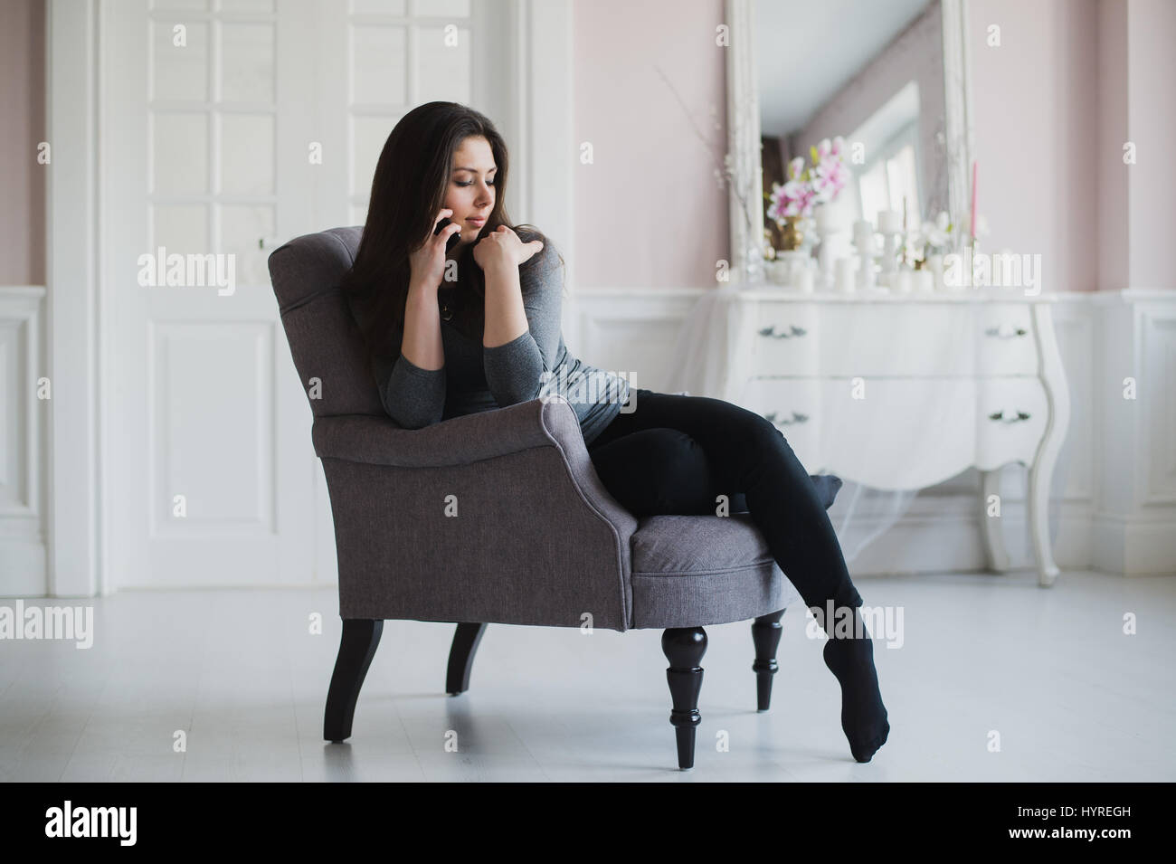 Shot of a casual woman talking with somebody on her mobile phone while ...