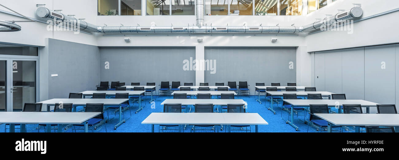 Panorama of modern college study hall in blue and grey with tables and ...