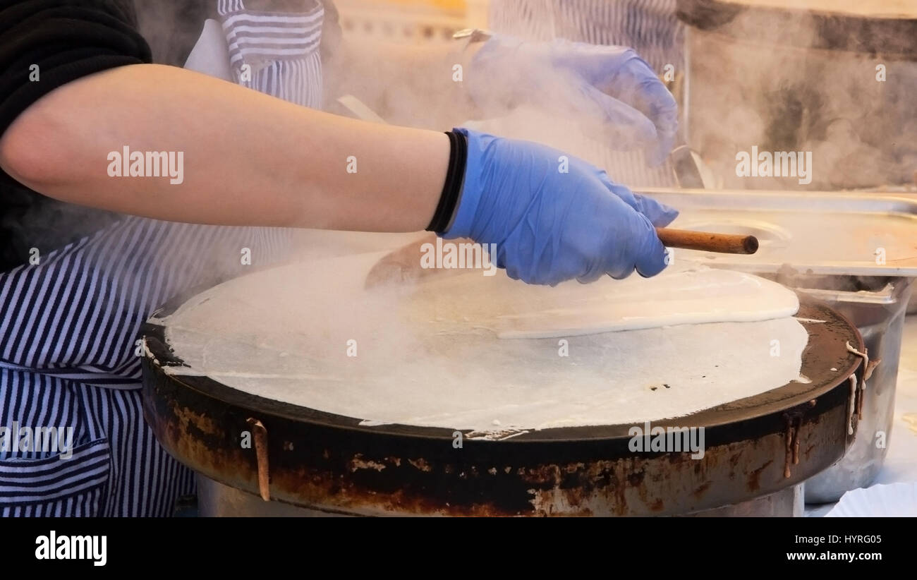 Woman cooking crepes in hi-res stock photography and images - Alamy