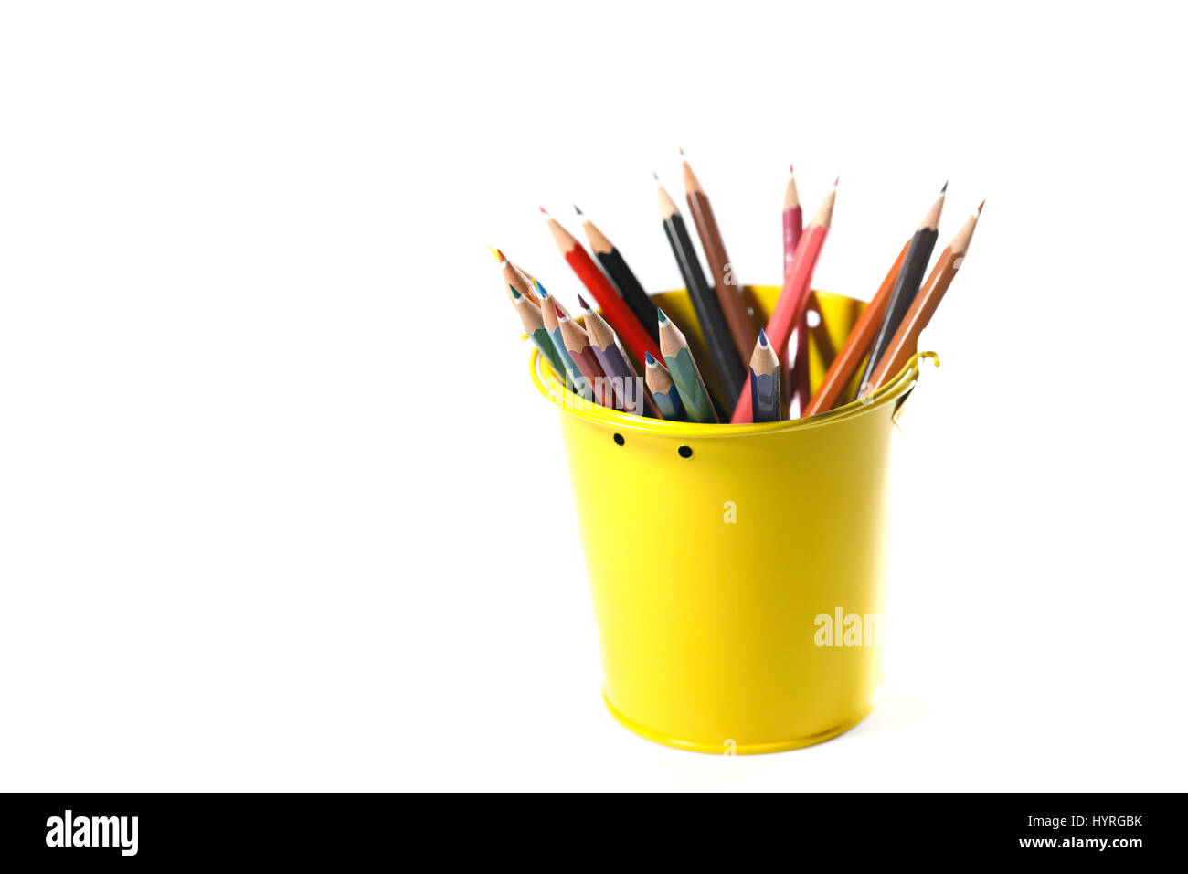 Color pencils in yellow bucket isolated on white background Stock Photo ...