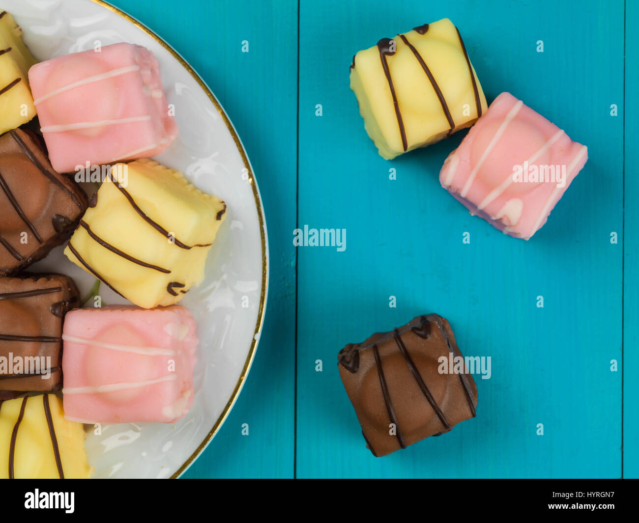 Iced Fondant Fancy Sponge Cakes Against a Blue Background Stock Photo ...
