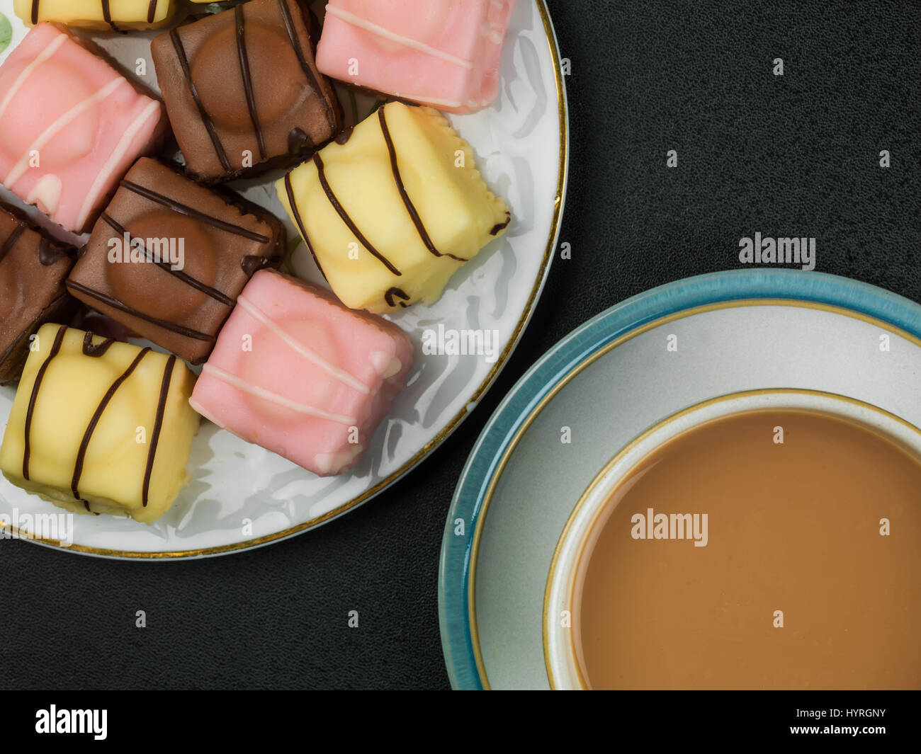 Iced Fondant Fancy Sponge Cakes Against a Black Background Stock Photo ...