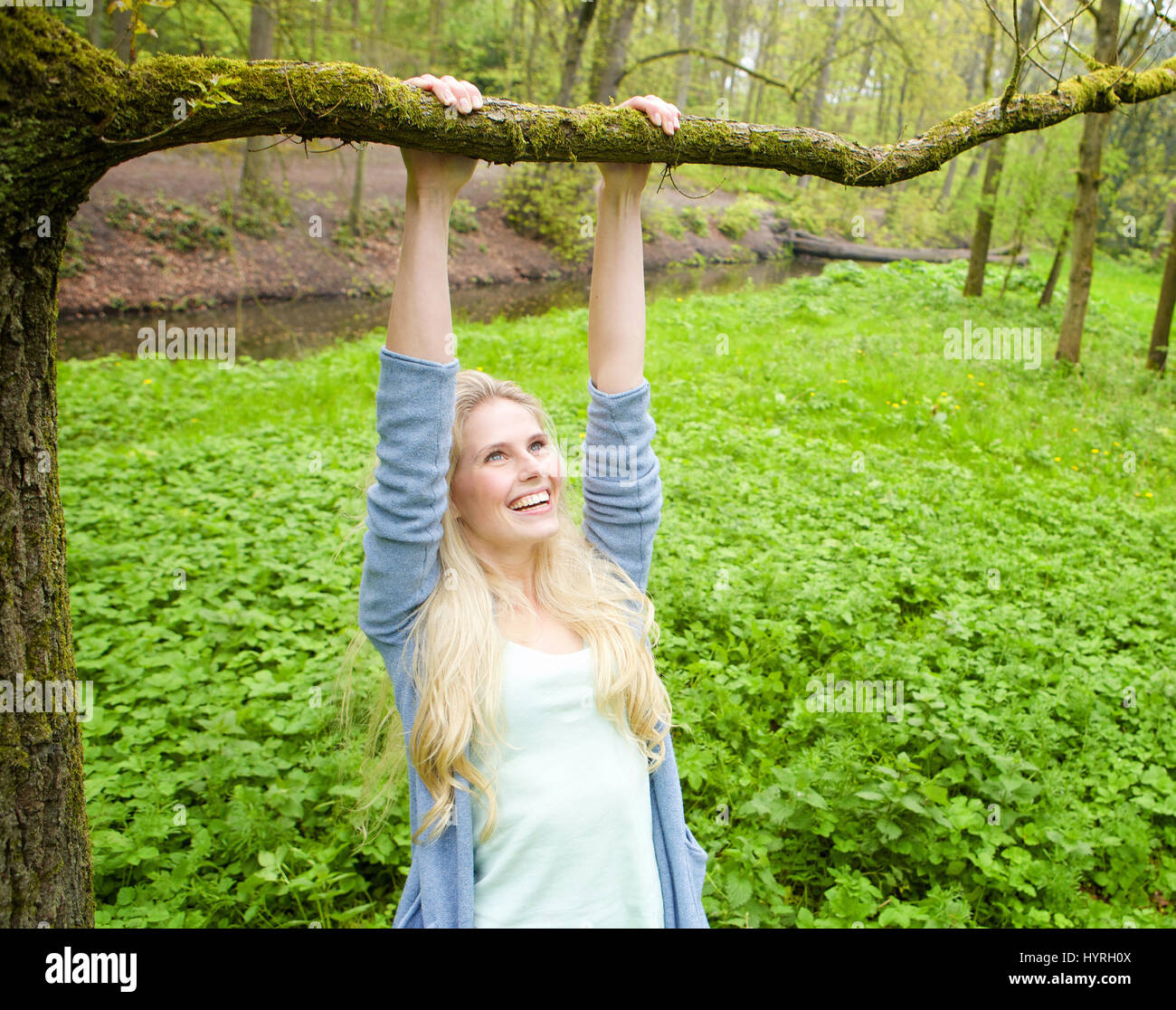 Woman climbing tree hi-res stock photography and images - Alamy