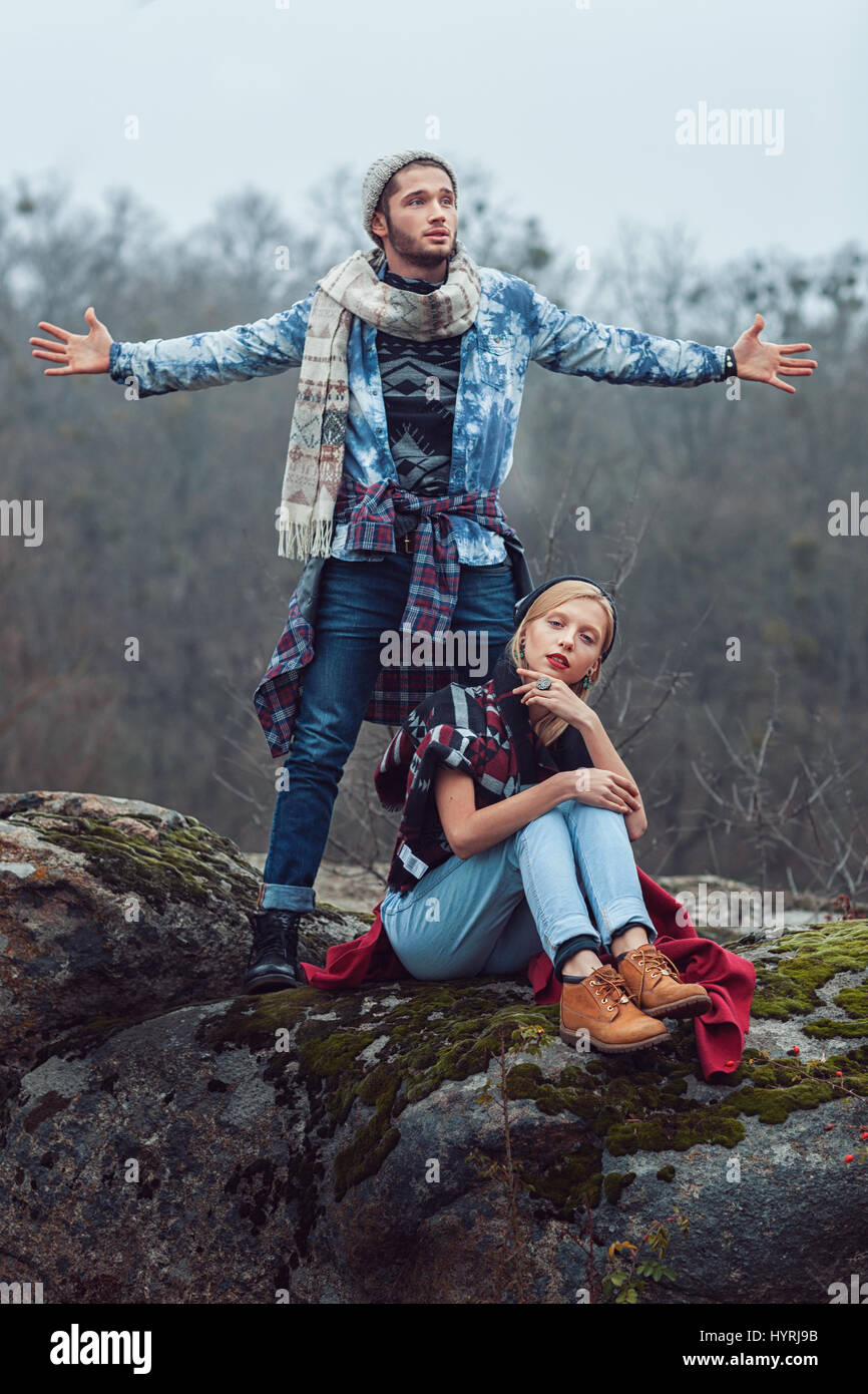Young people derive pleasure standing on the rock Stock Photo - Alamy