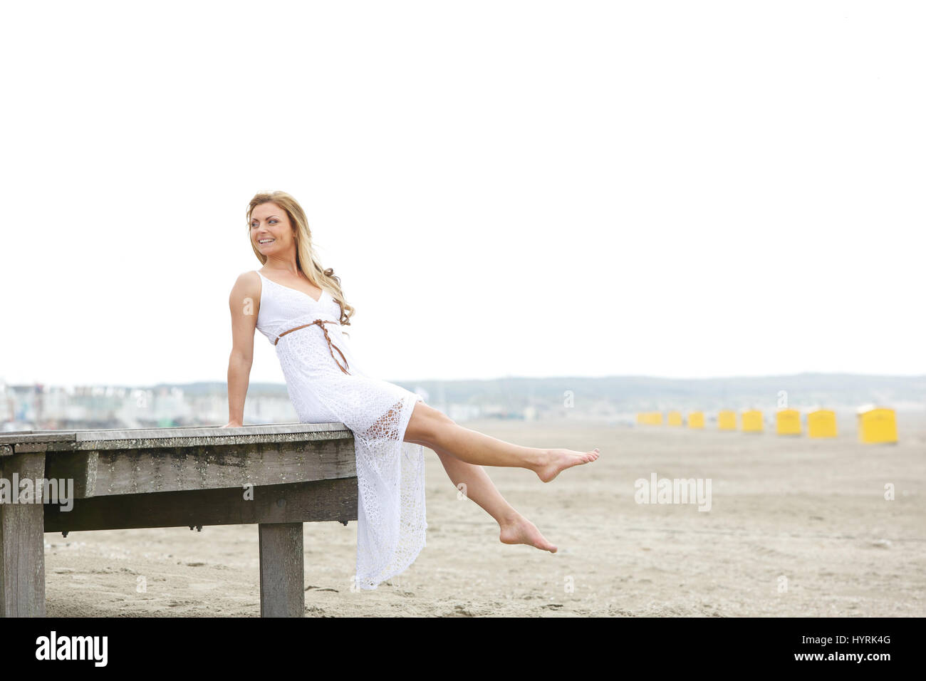Elegant woman sitting beach hi-res stock photography and images - Alamy