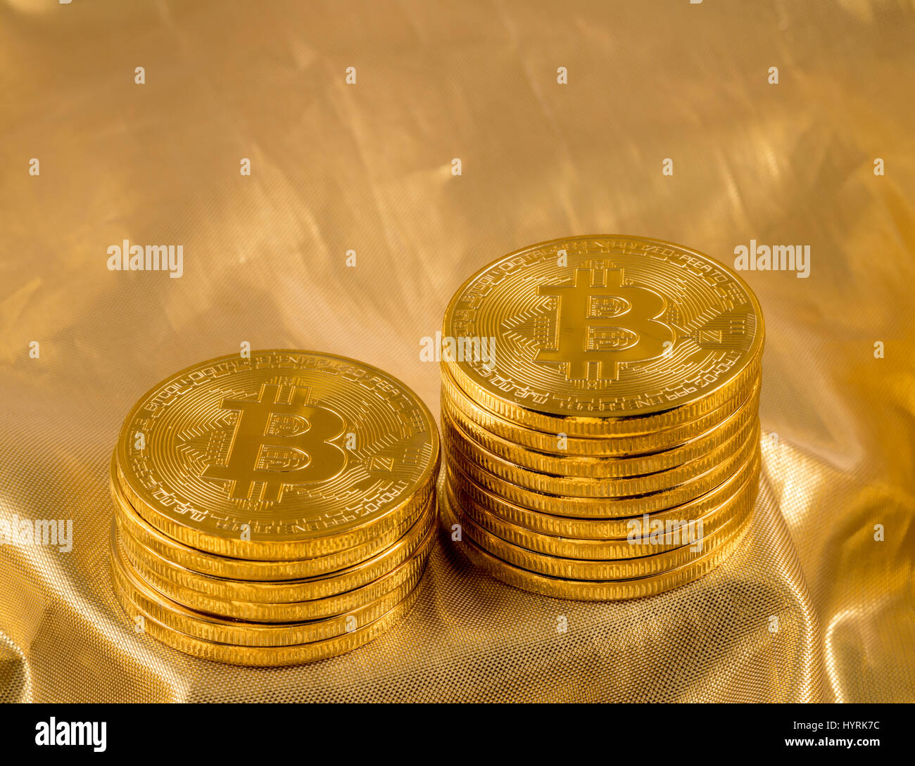 Stack of bitcoins with gold background Stock Photo - Alamy
