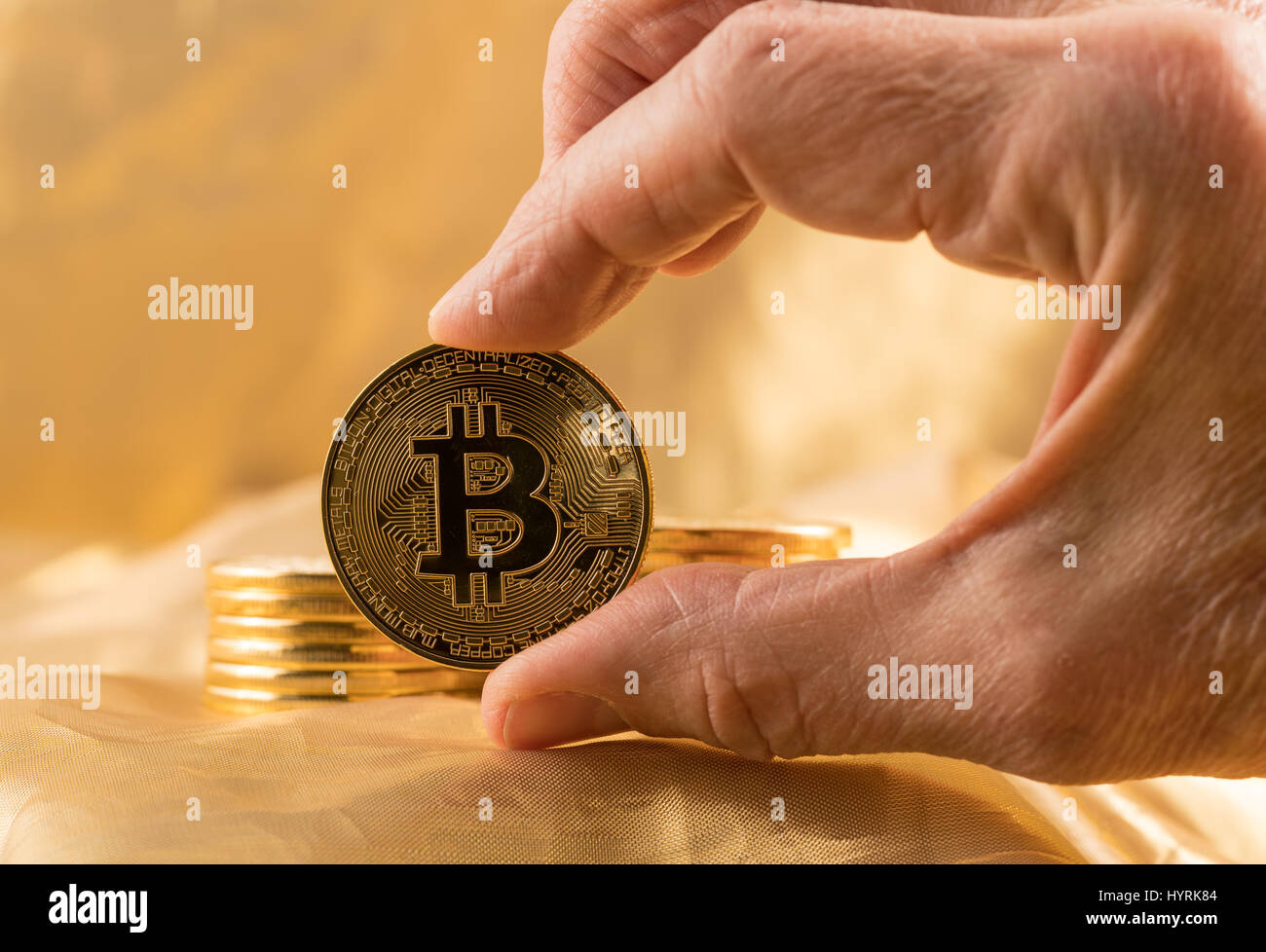 Stack of bitcoins with gold background Stock Photo - Alamy