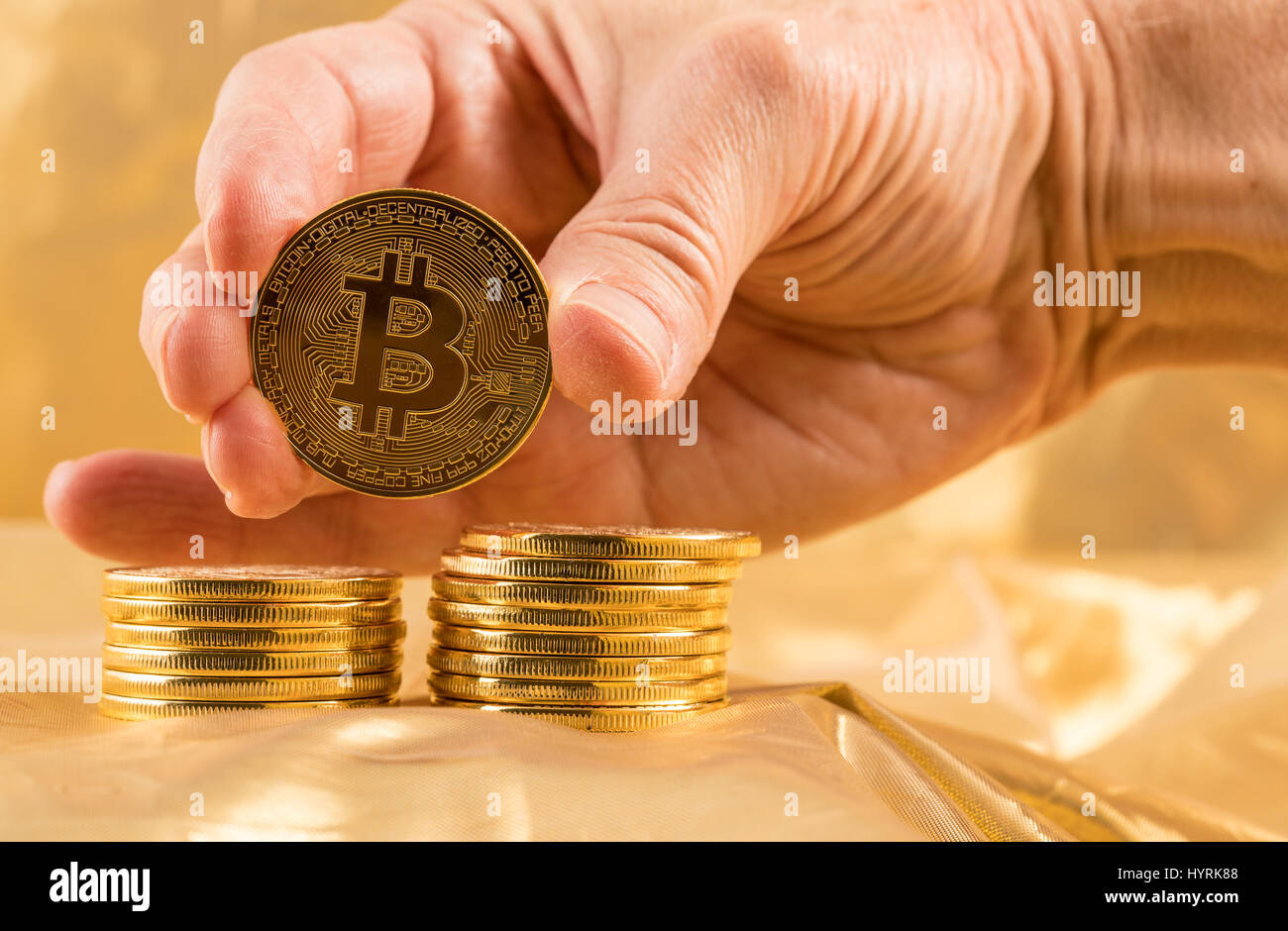 Stack of bitcoins with gold background Stock Photo - Alamy