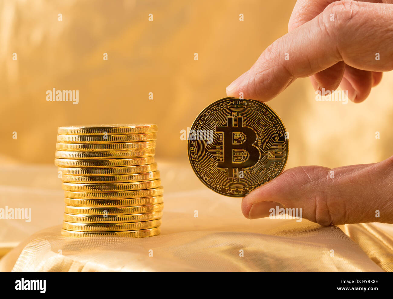 Stack of bitcoins with gold background Stock Photo - Alamy