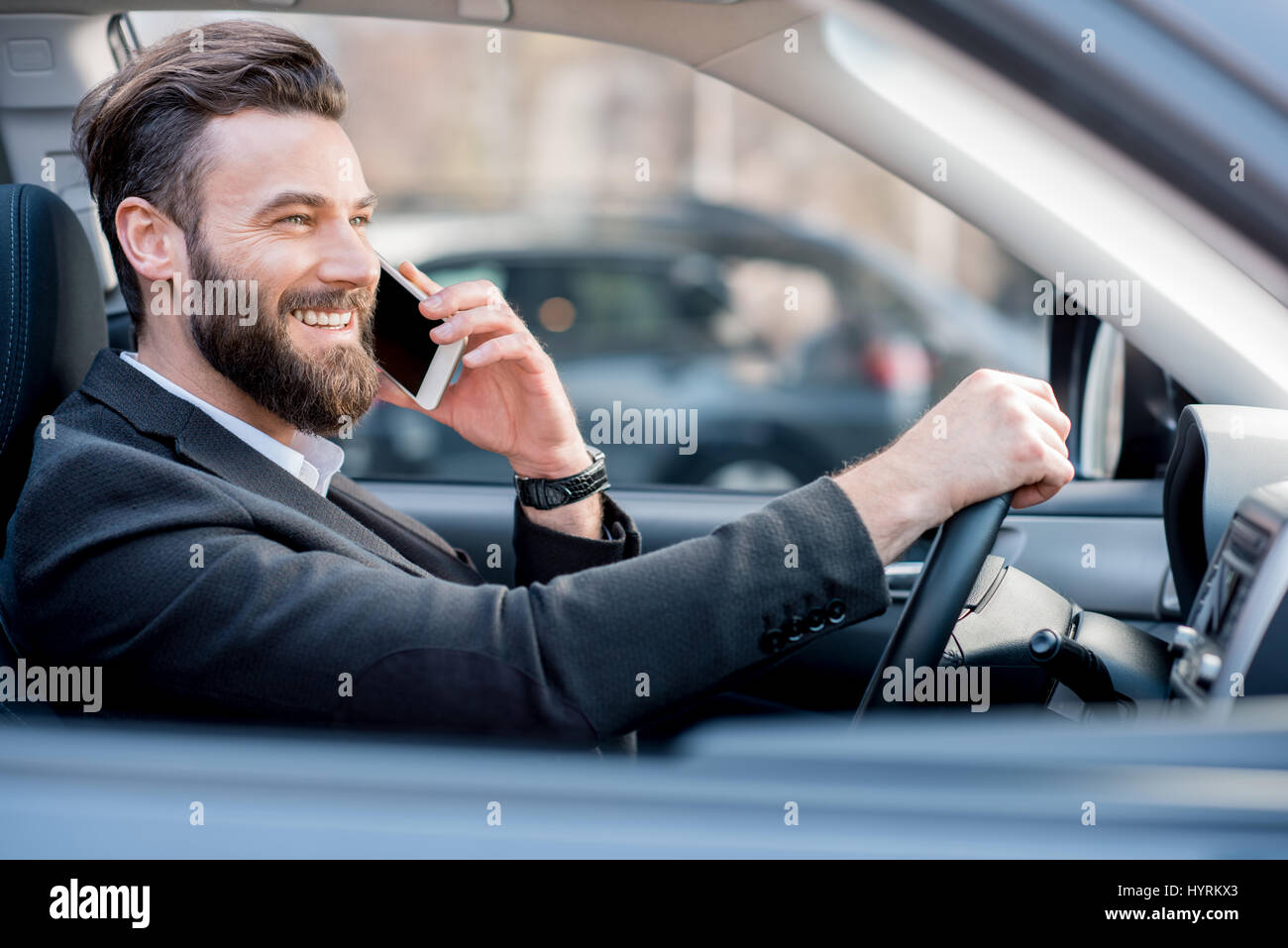 Businessman driving a car Stock Photo - Alamy