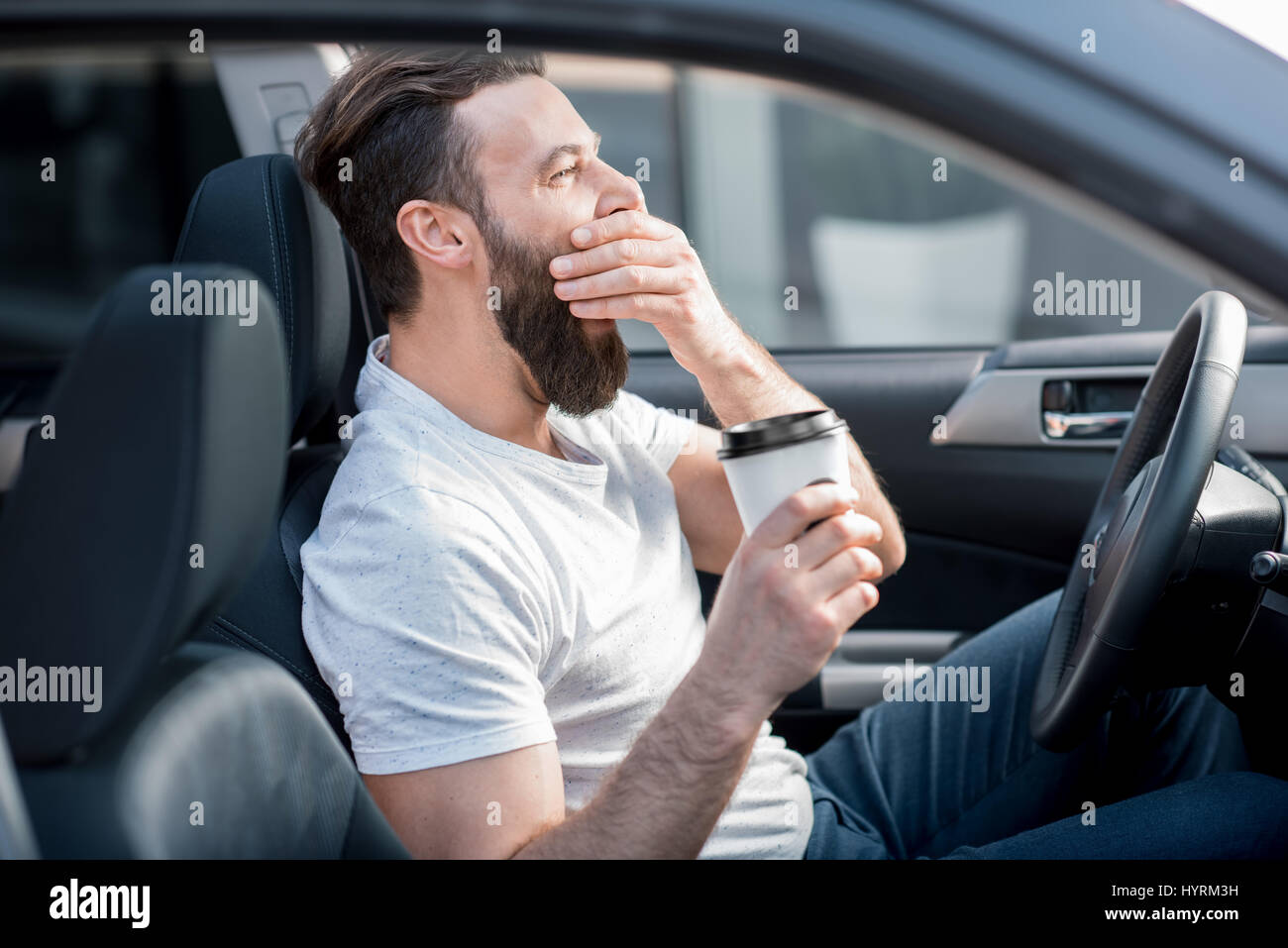 Tired man driving a car Stock Photo - Alamy