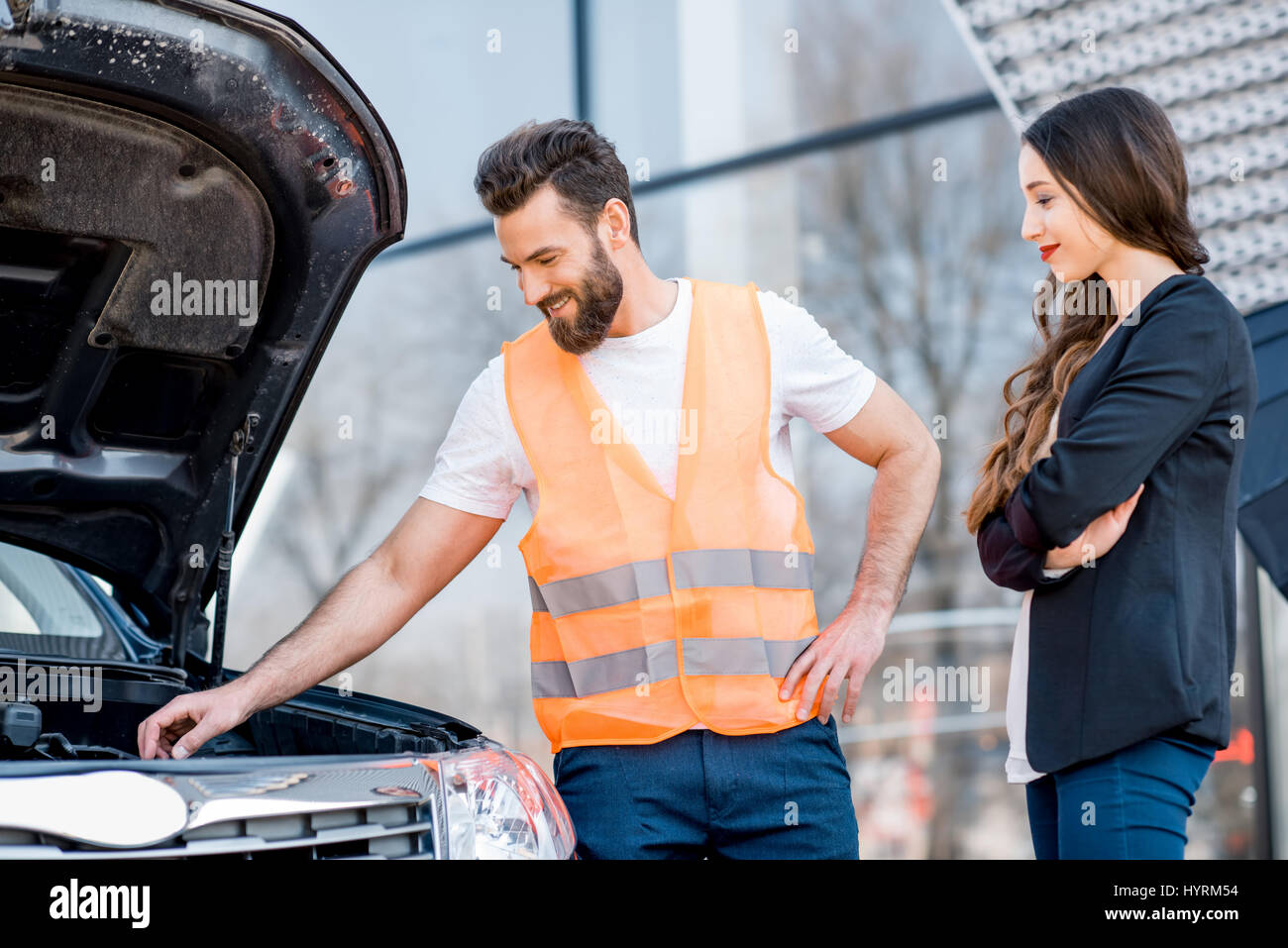 Man providing car technical assistance Stock Photo - Alamy