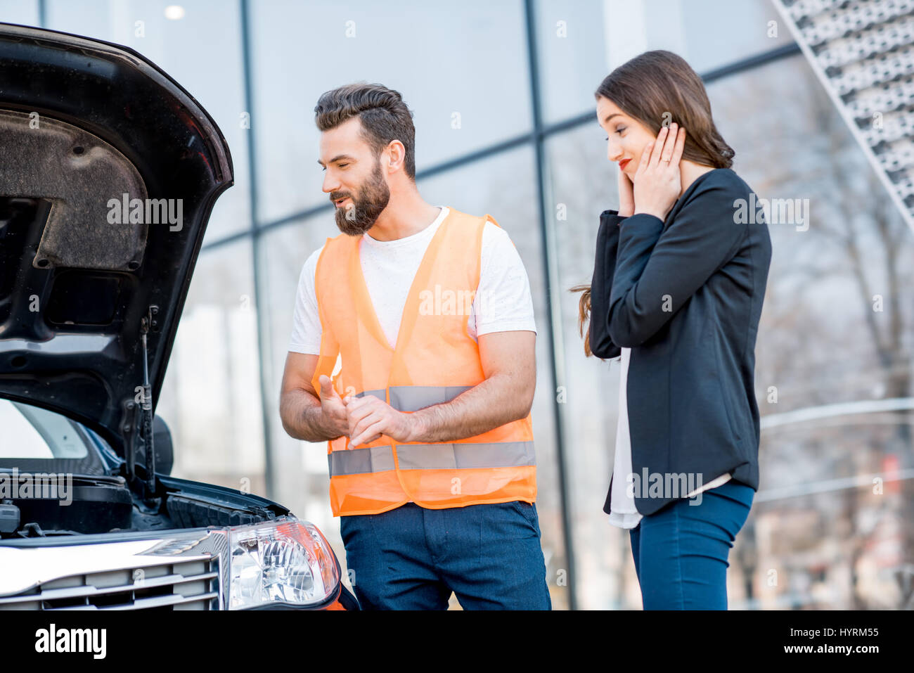 Man providing car technical assistance Stock Photo - Alamy