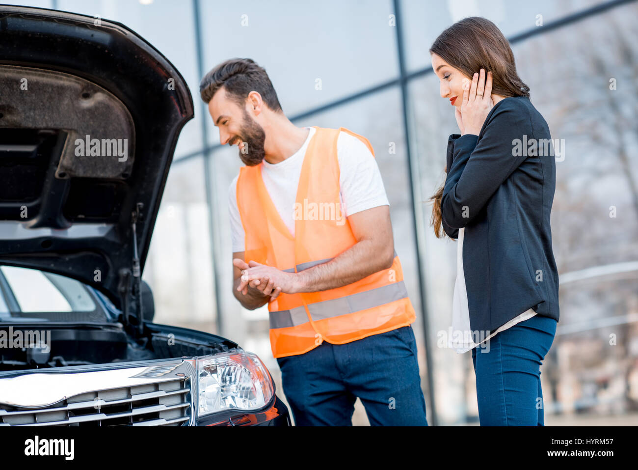 Man providing car technical assistance Stock Photo - Alamy