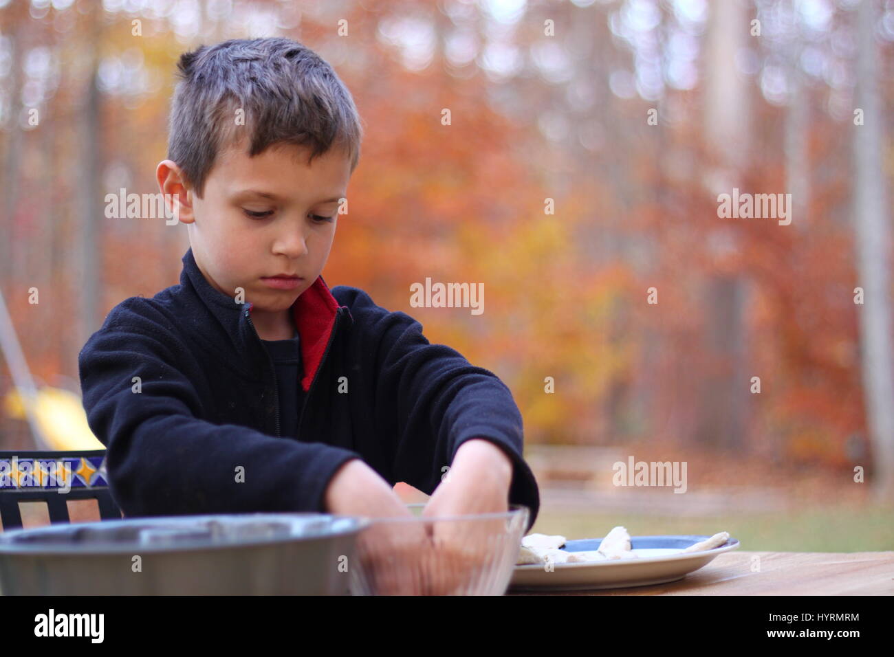 young boy preparing food outside on table Stock Photo - Alamy