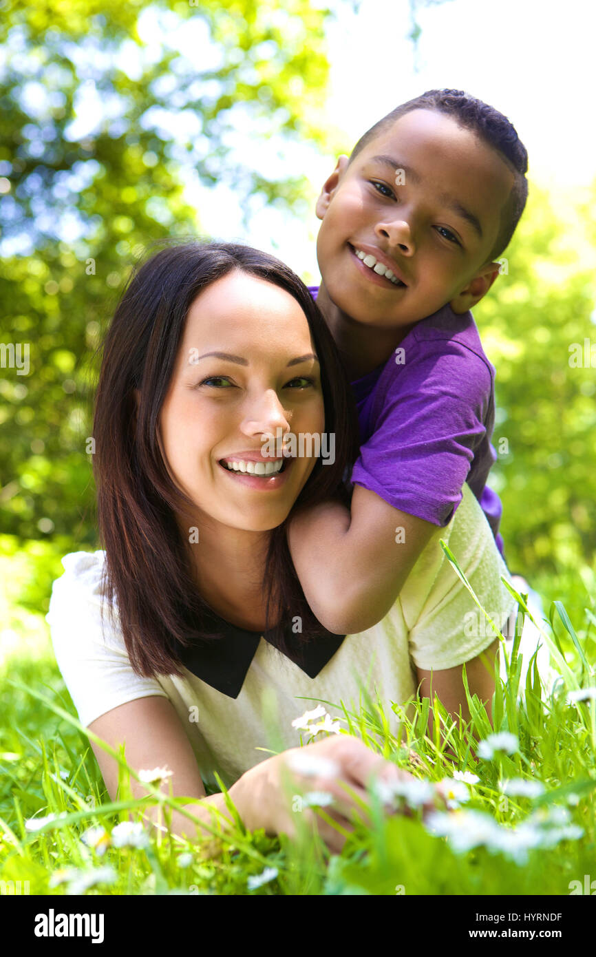 Portrait of a happy mother and son smiling together outdoors in the ...