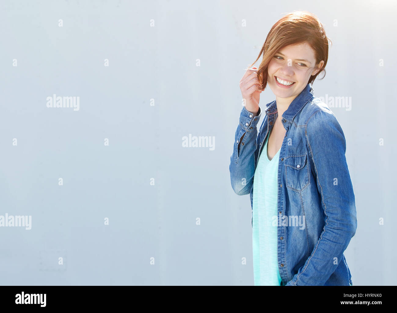 Profile portrait of a beautiful young woman smiling outdoors Stock ...
